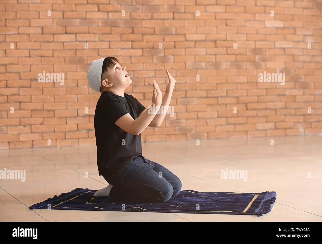 Little Muslim boy praying indoors Stock Photo - Alamy