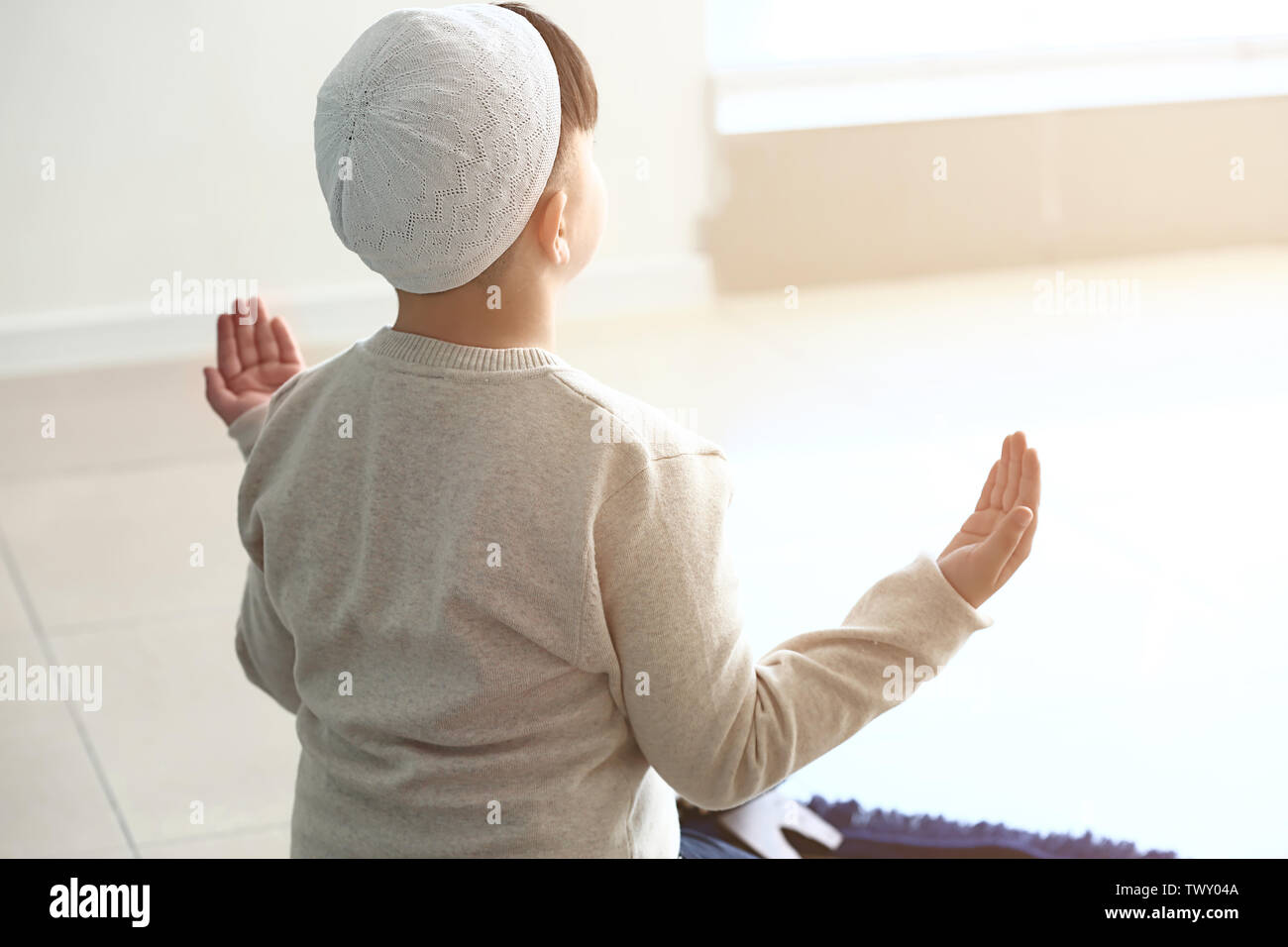 Little Muslim boy praying indoors Stock Photo - Alamy