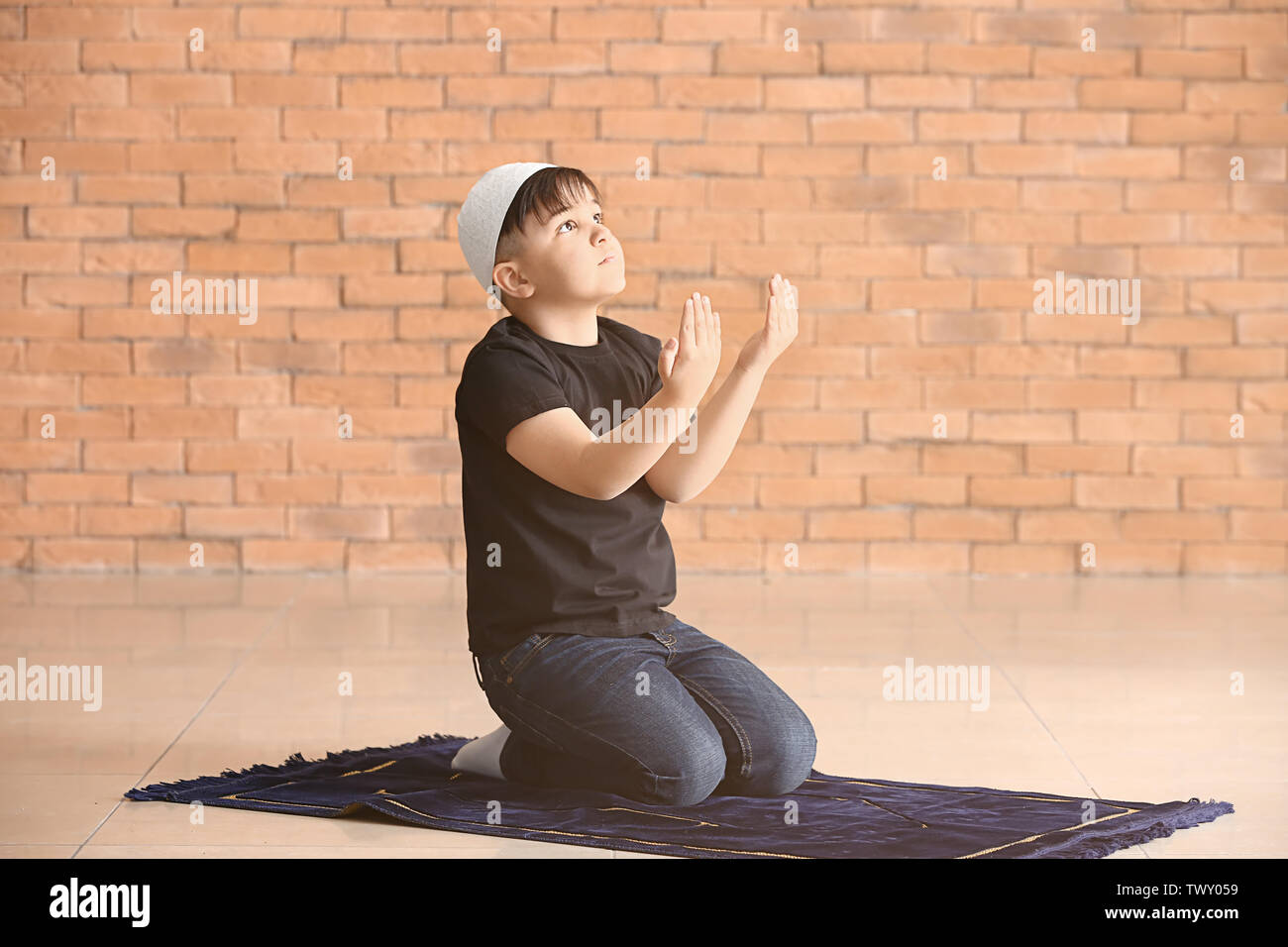 Little Muslim boy praying indoors Stock Photo - Alamy