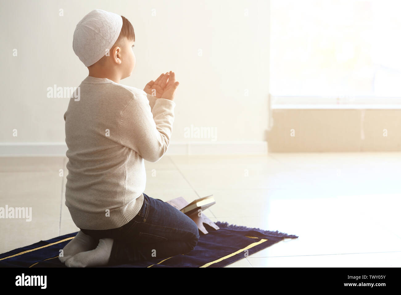 Little Muslim boy praying indoors Stock Photo - Alamy