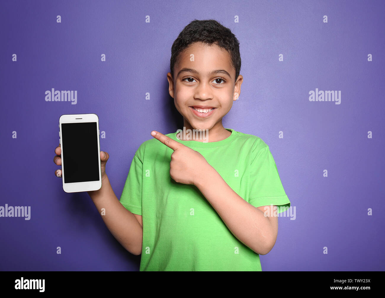 Cute little boy with mobile phone on color background Stock Photo - Alamy