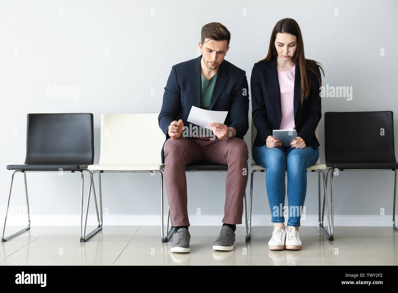 Young people waiting for job interview indoors Stock Photo - Alamy