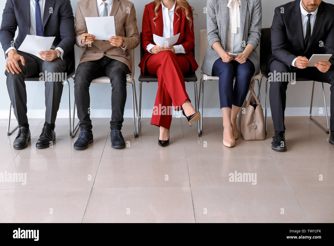 Young people waiting for job interview indoors Stock Photo - Alamy