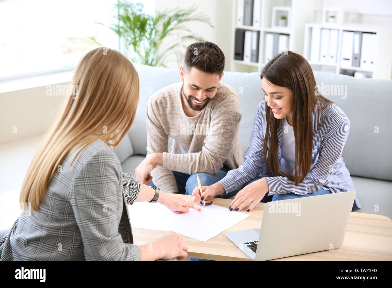 Young couple in office of real estate agent Stock Photo - Alamy