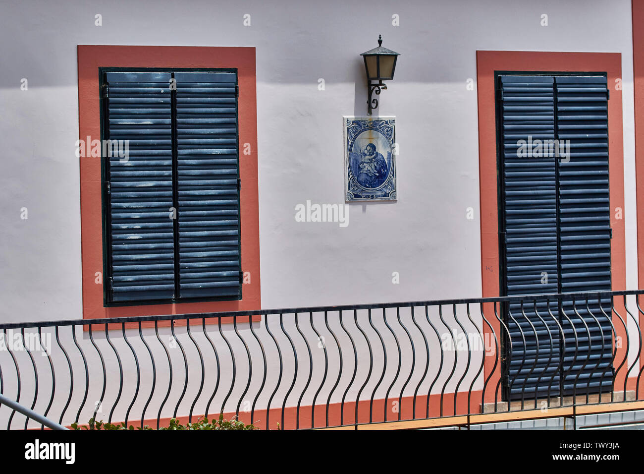 Architectural abstract of balcony rail plain wall and wooden shutters ...