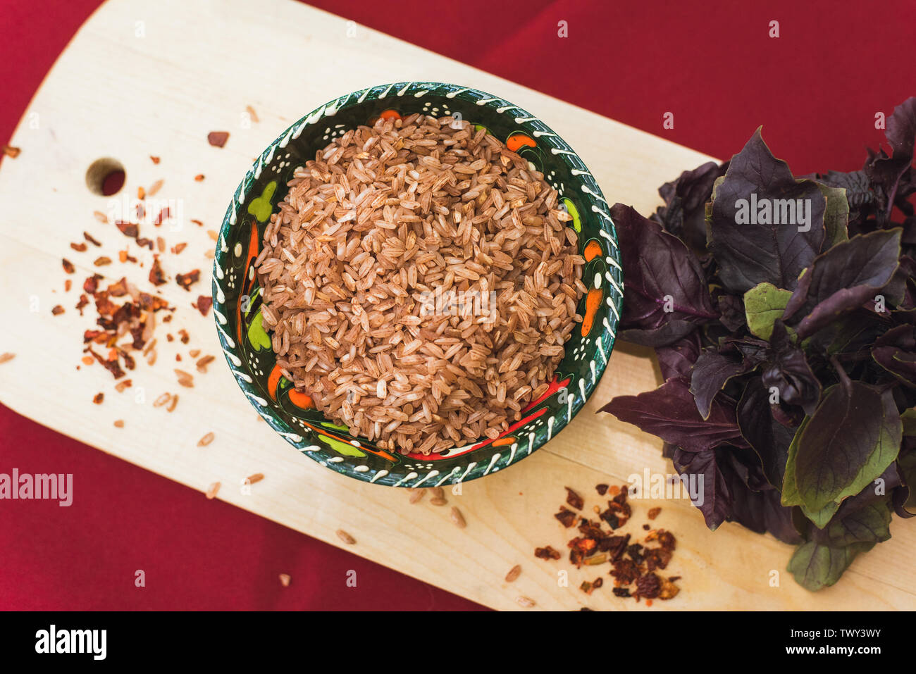 Zira rice lies in an oriental plate. dark rice lies on an oriental ...