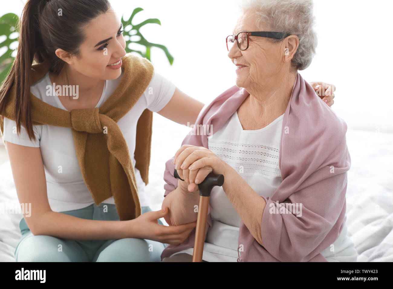 Caregiver with senior woman in nursing home Stock Photo - Alamy