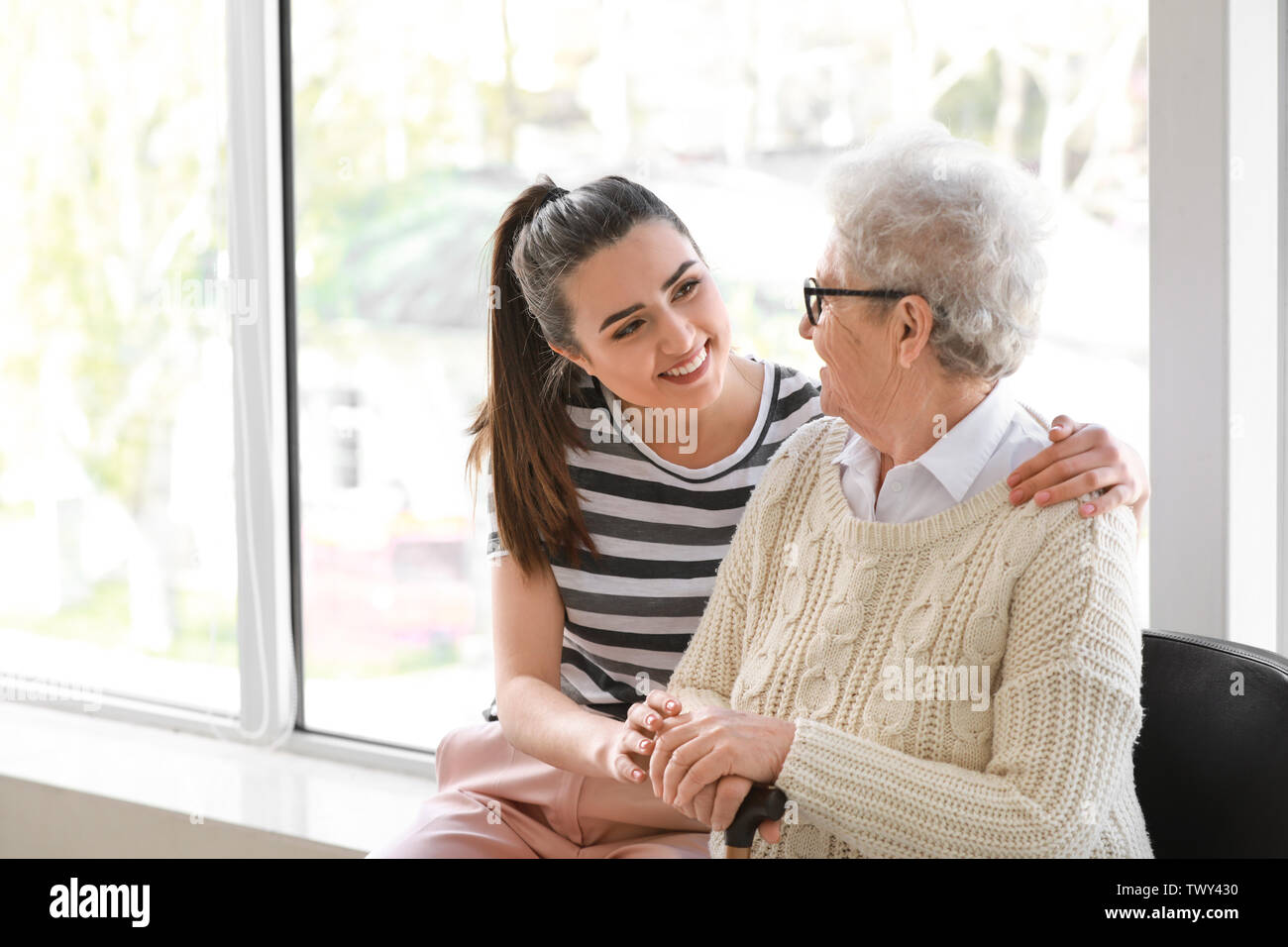 Caregiver with senior woman in nursing home Stock Photo - Alamy