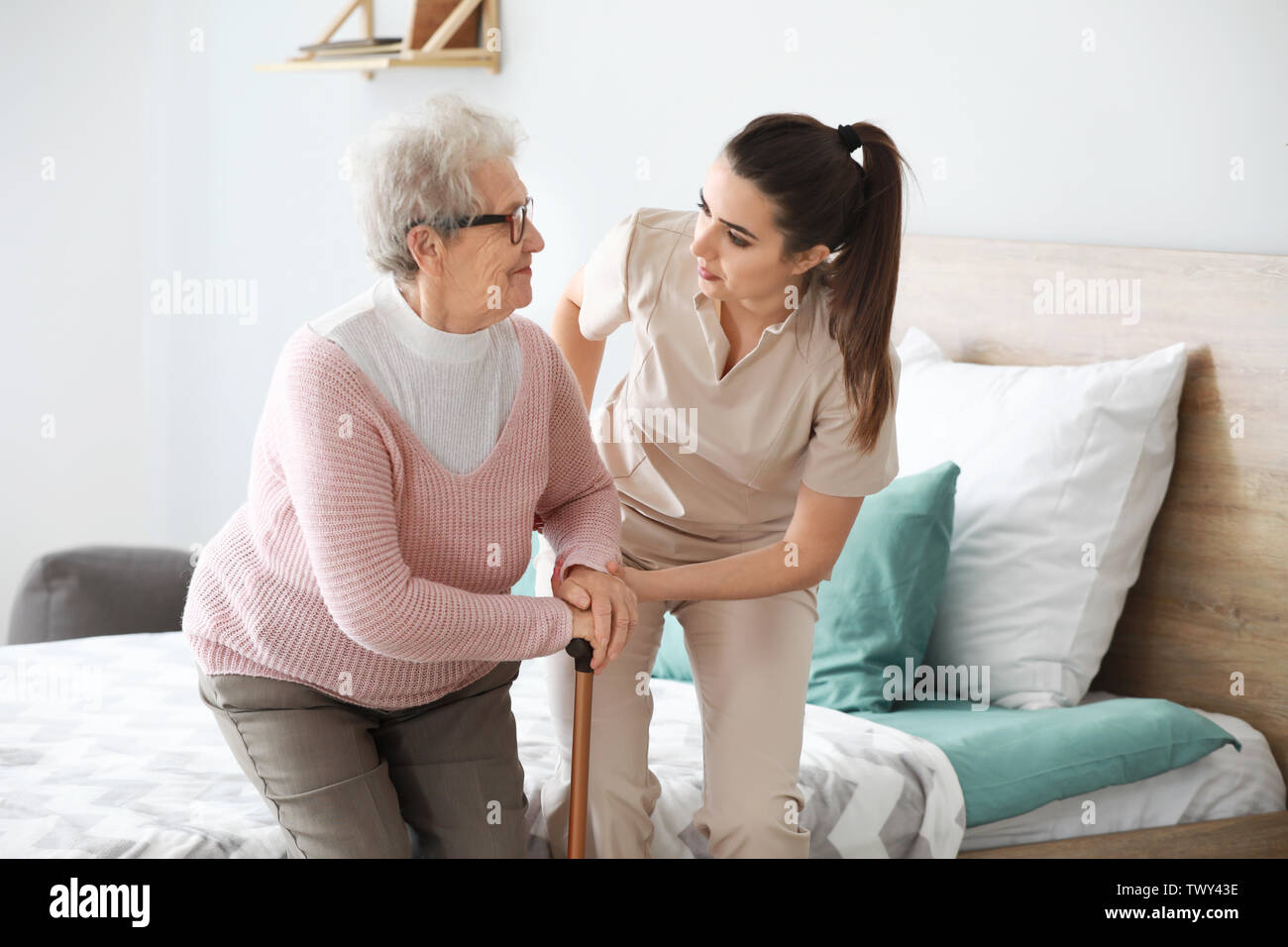 Caregiver with senior woman in nursing home Stock Photo - Alamy