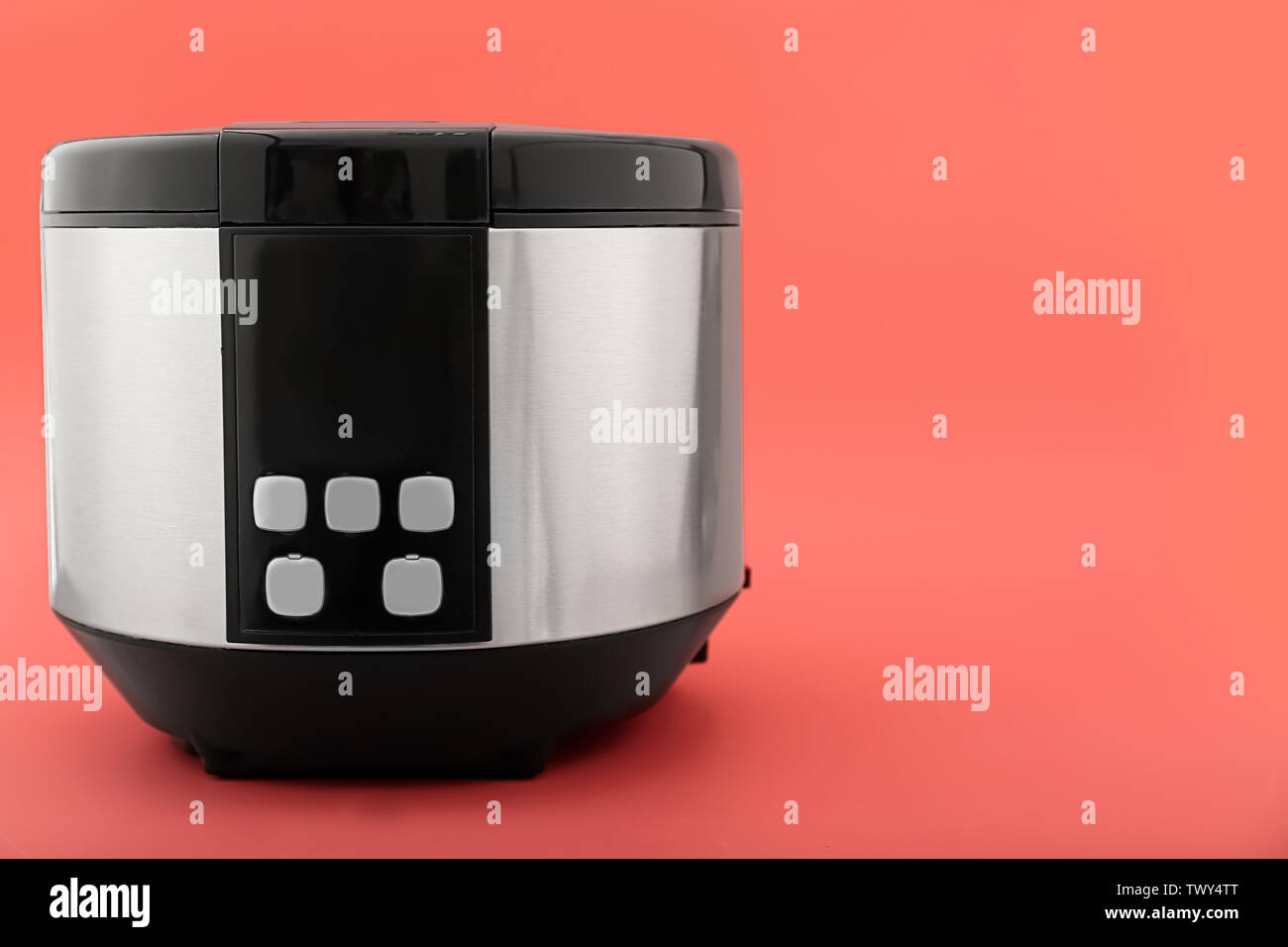 Modern multi cooker on color background Stock Photo - Alamy