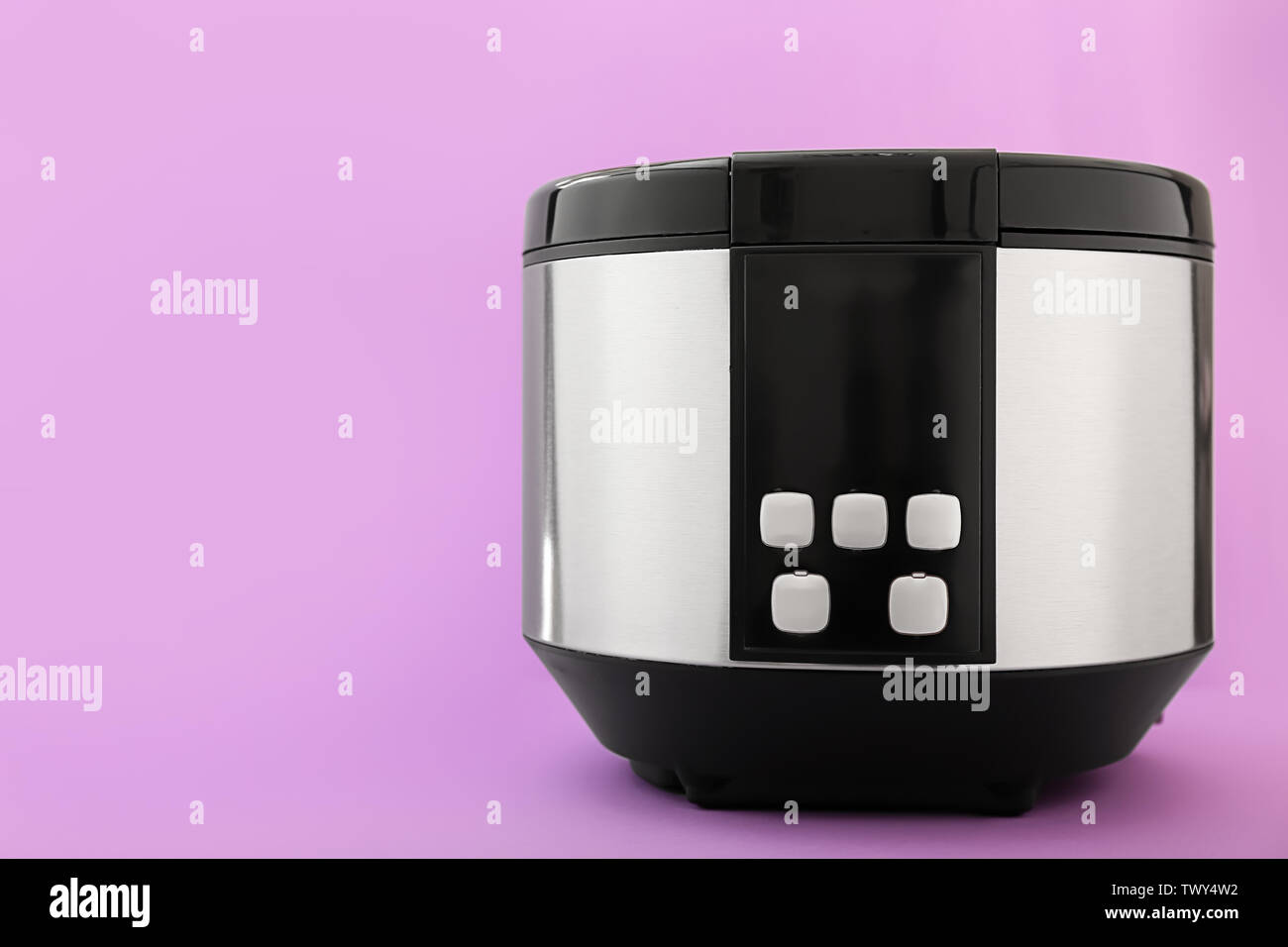 Modern multi cooker on color background Stock Photo - Alamy