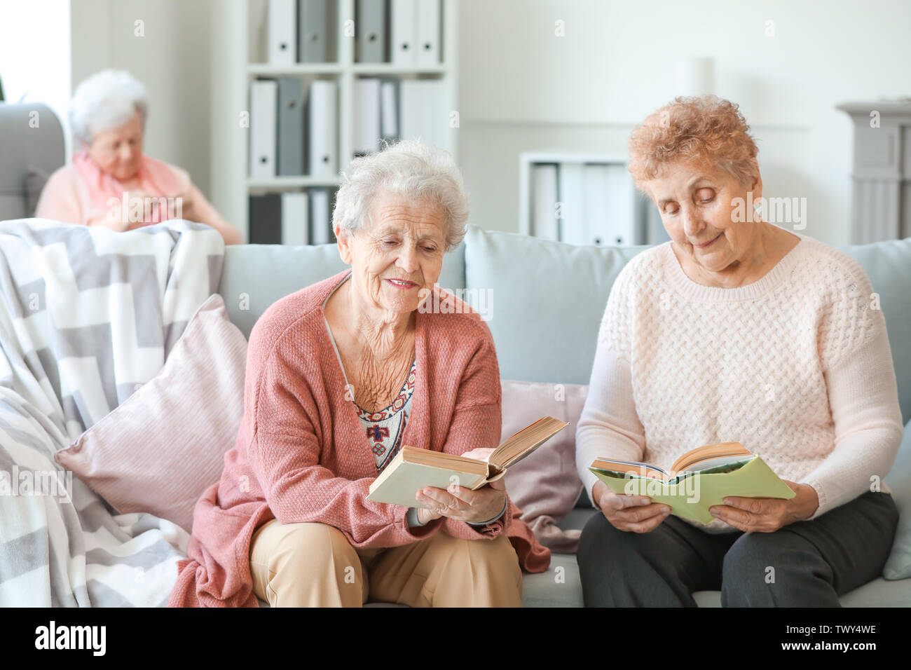 Senior women reading books in nursing home Stock Photo - Alamy