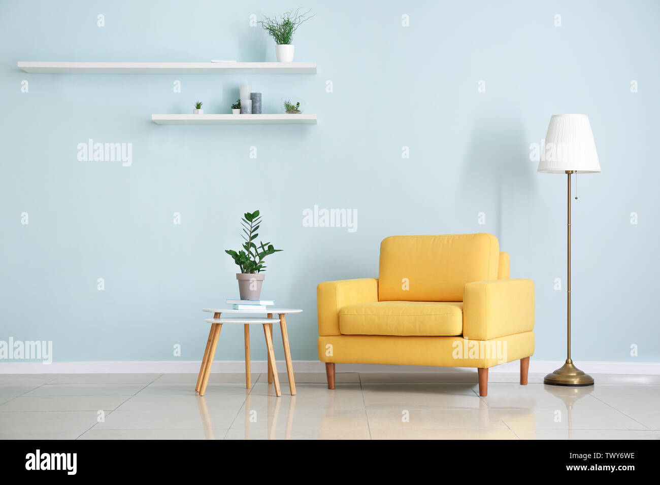 Interior of modern room with armchair and table Stock Photo - Alamy