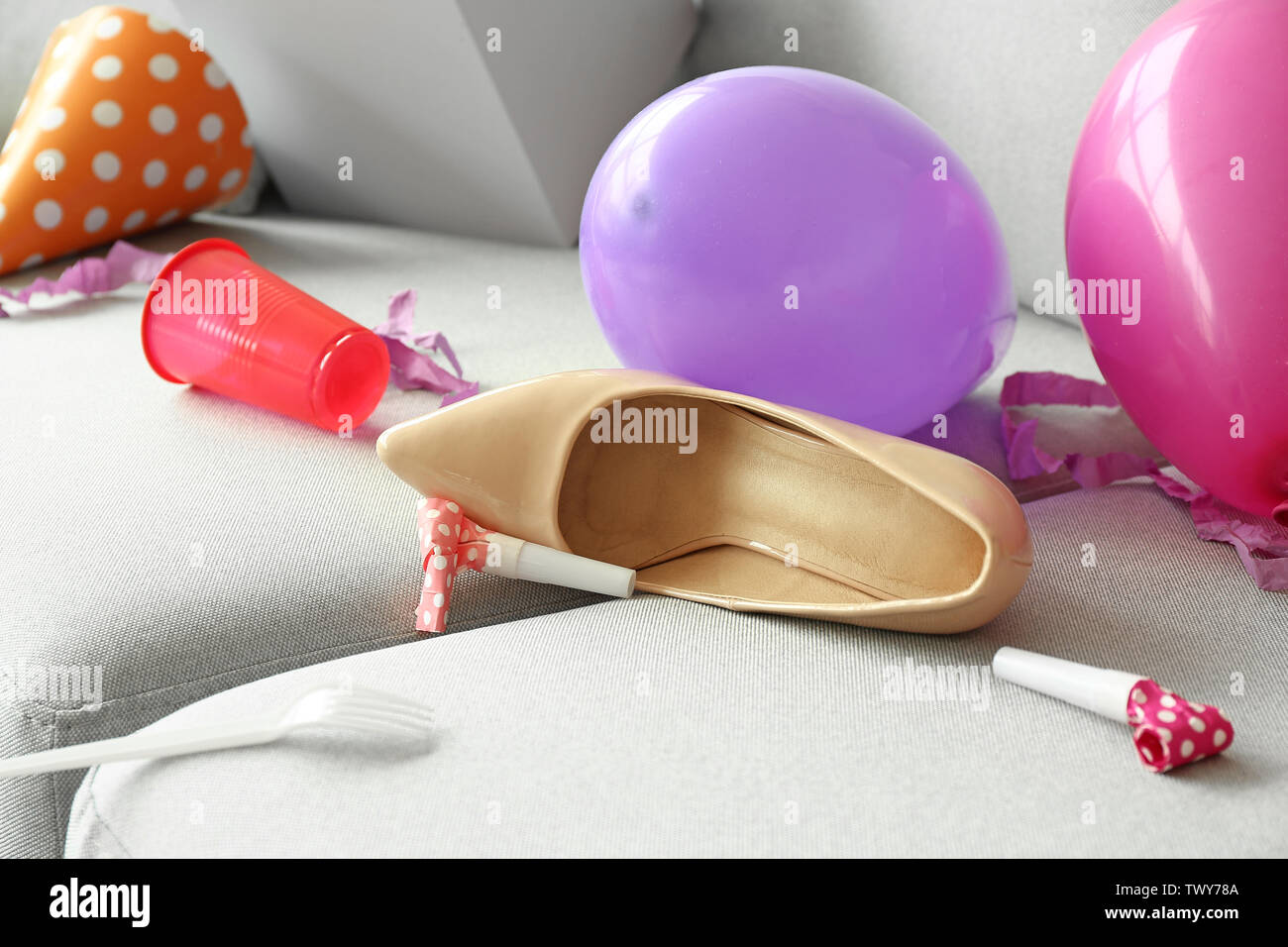 Sofa with trash after party in room Stock Photo - Alamy