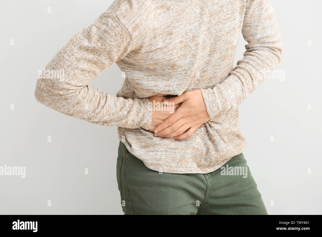Man suffering from pain in side on white background Stock Photo - Alamy