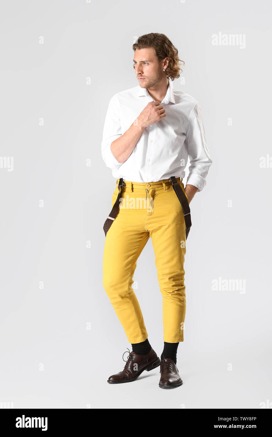 Stylish young man on white background Stock Photo - Alamy