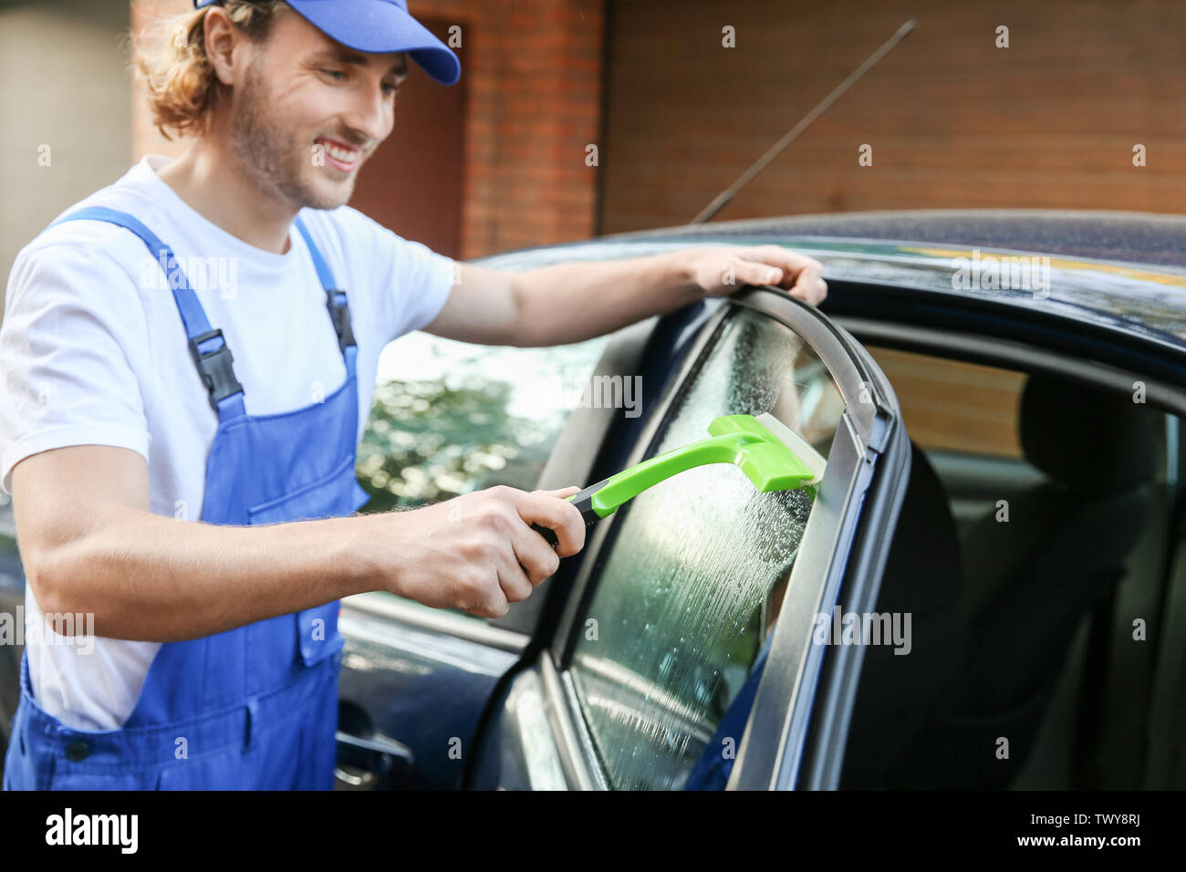 Male worker tinting car window outdoors Stock Photo - Alamy