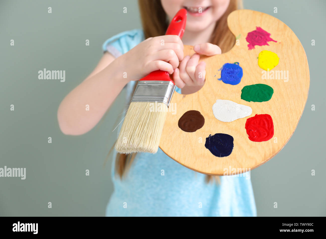 Cute little artist on color background Stock Photo - Alamy