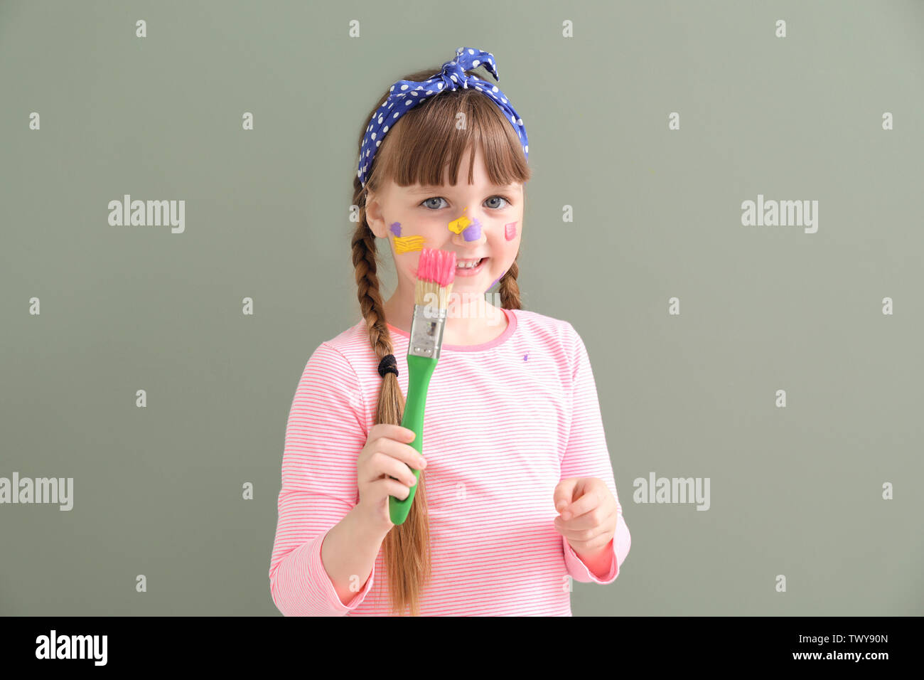 Cute little artist on color background Stock Photo - Alamy