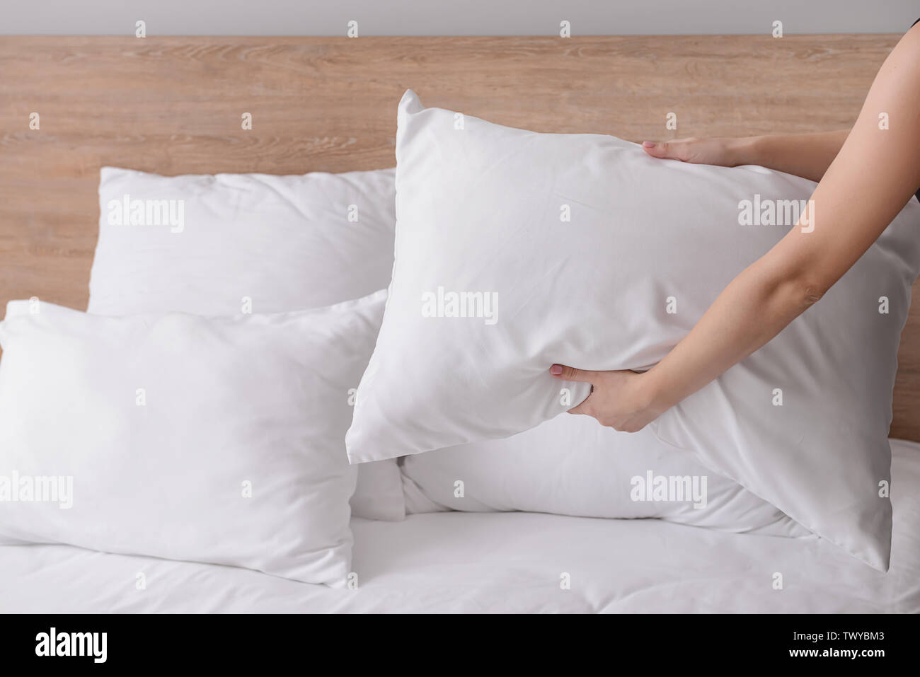 Woman fluffing pillows hi-res stock photography and images - Alamy