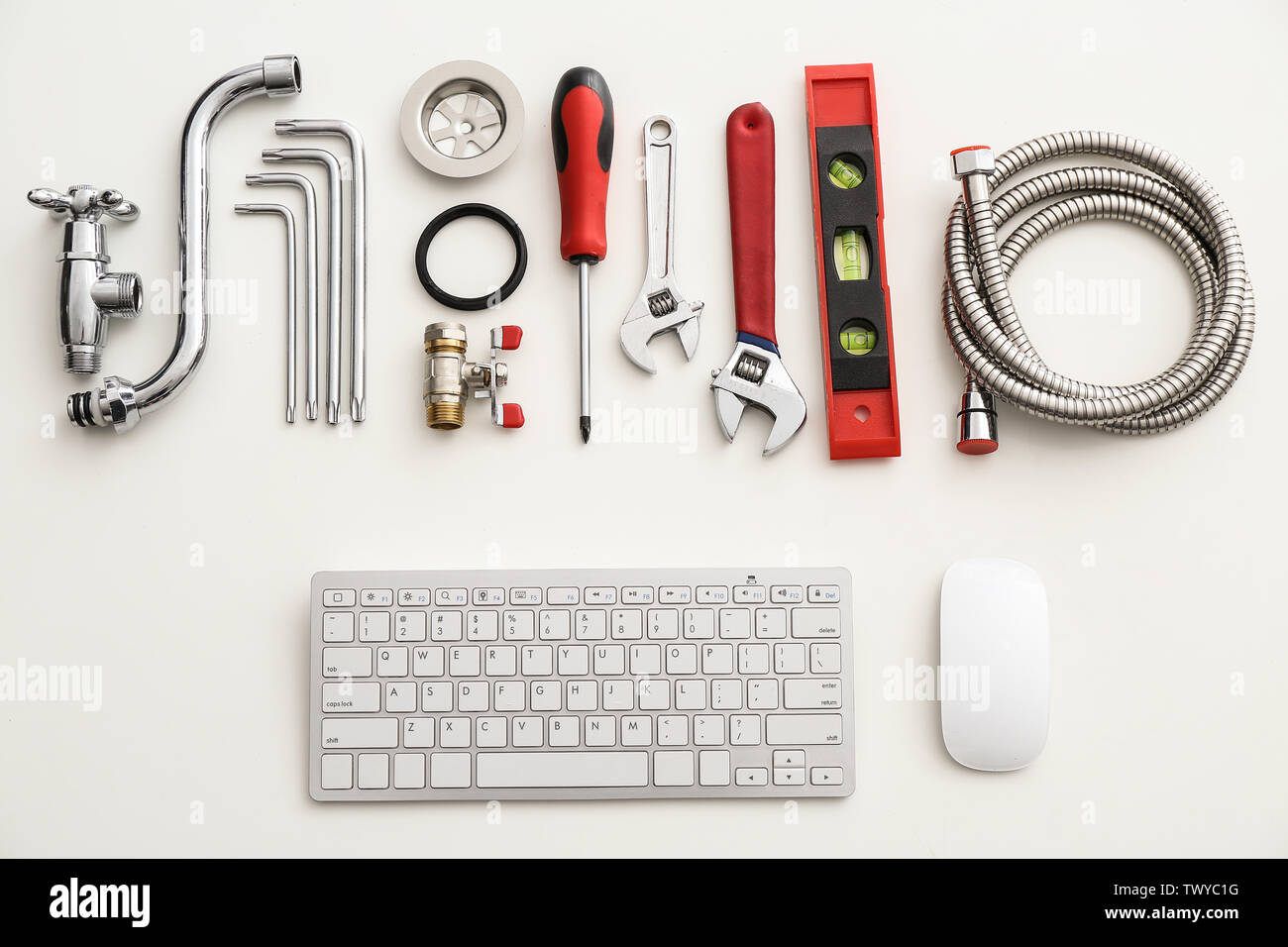 Computer keyboard and plumbing items on white background Stock Photo ...