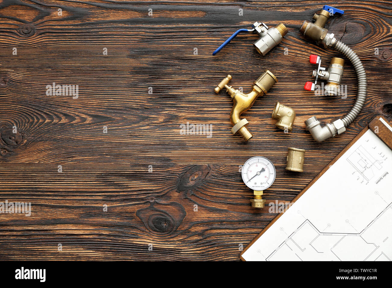Set of plumbing items with house plan on wooden background Stock Photo ...