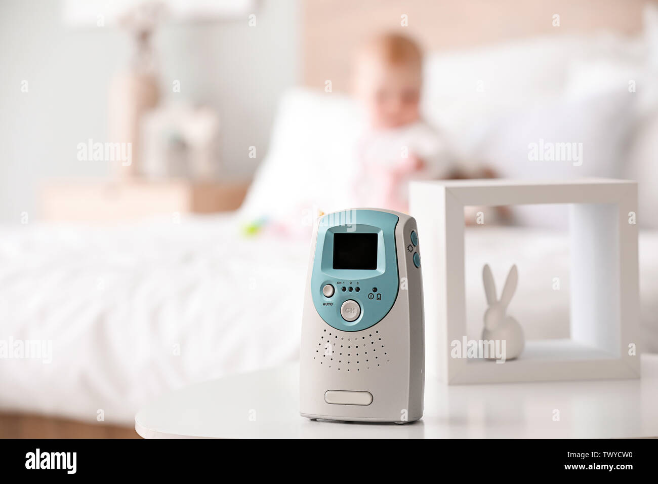 Modern baby monitor on table in room with little child Stock Photo - Alamy