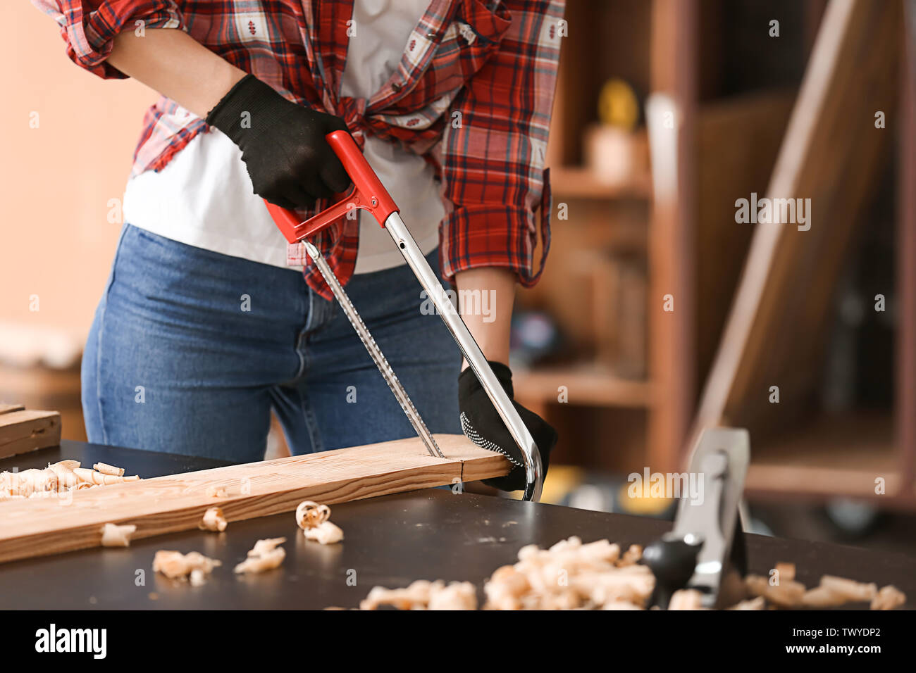 Closeup female carpenter cutting wood hi-res stock photography and ...