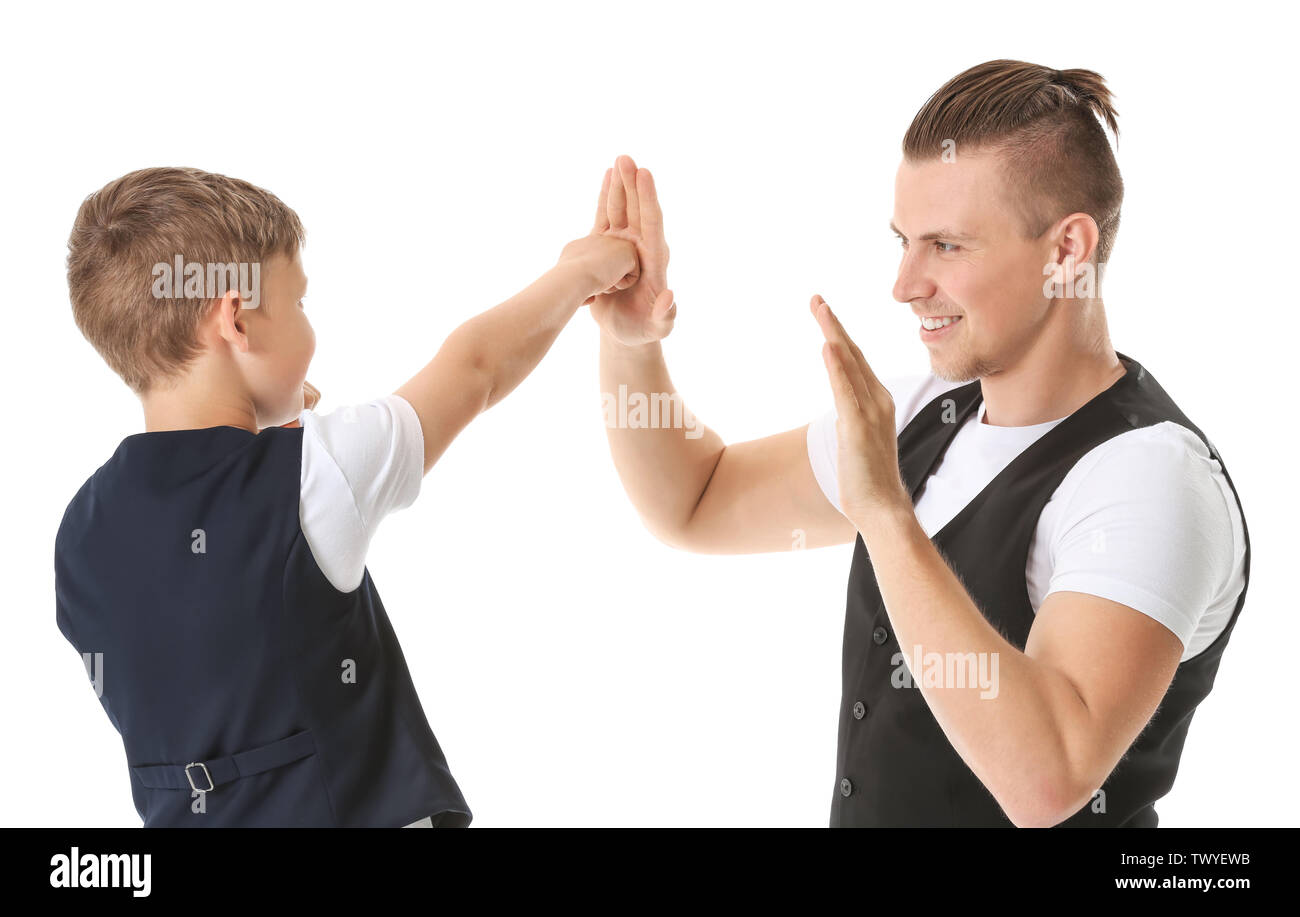 Portrait of father teaching his son to fight on white background Stock ...