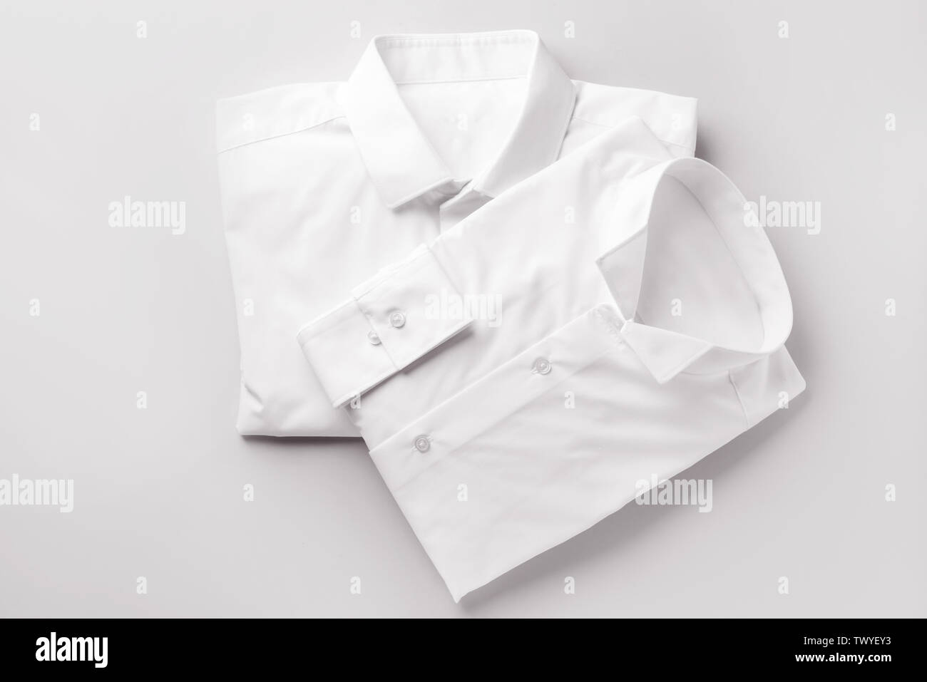 Shirts after dry-cleaning on light background Stock Photo - Alamy