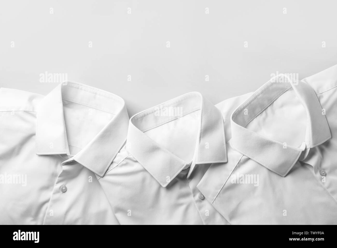 Shirts after dry-cleaning on light background Stock Photo - Alamy