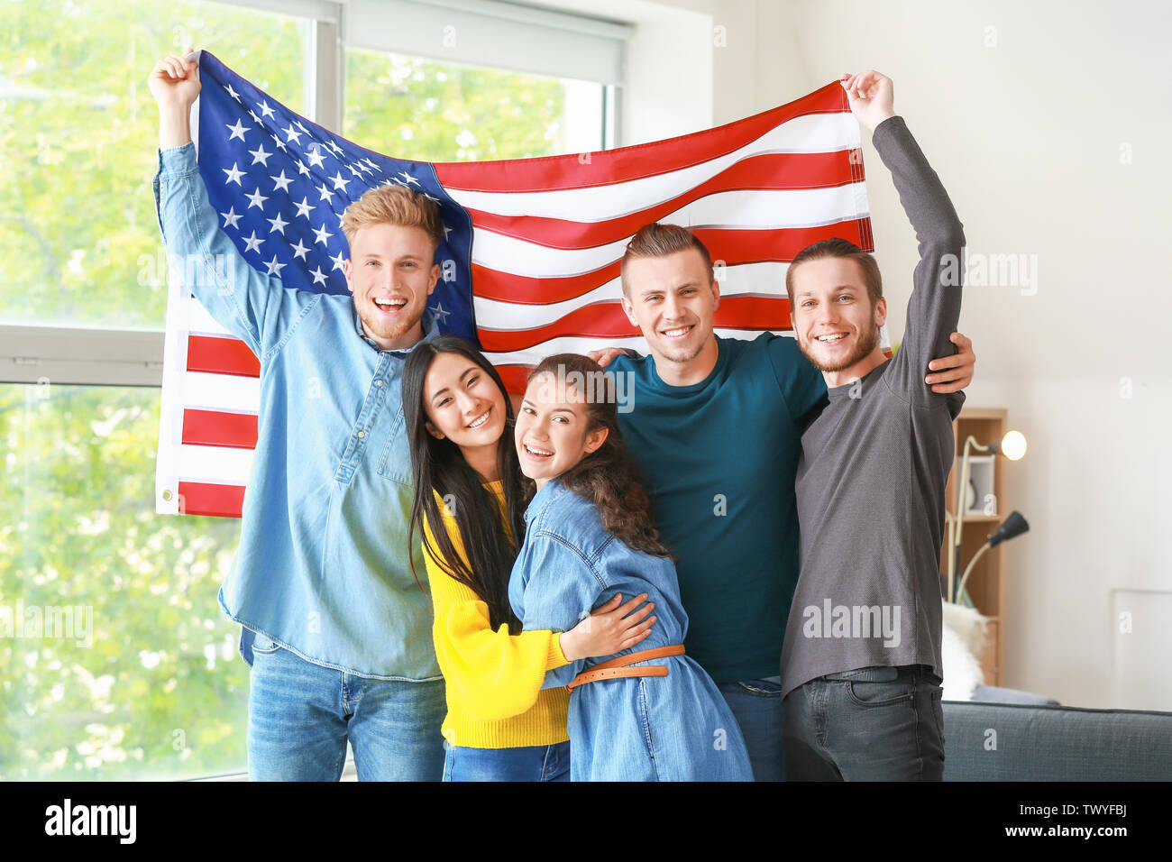 Happy friends with USA flag at home. Independence Day celebration Stock ...