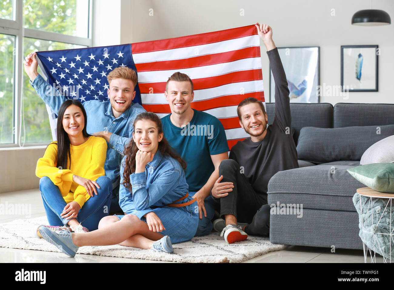 Happy friends with USA flag at home. Independence Day celebration Stock ...