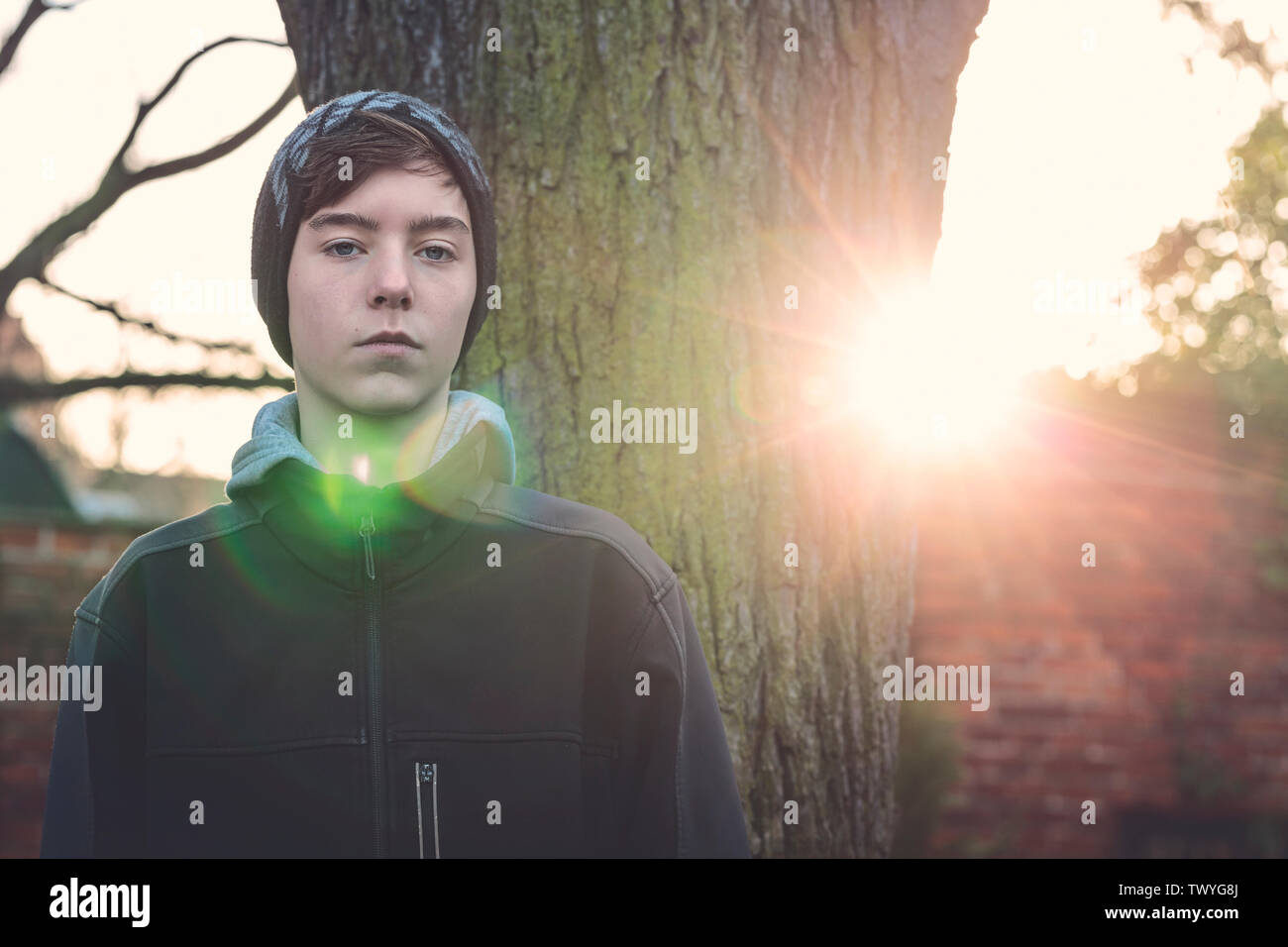 portrait of a serious young man, shot against the sun Stock Photo - Alamy