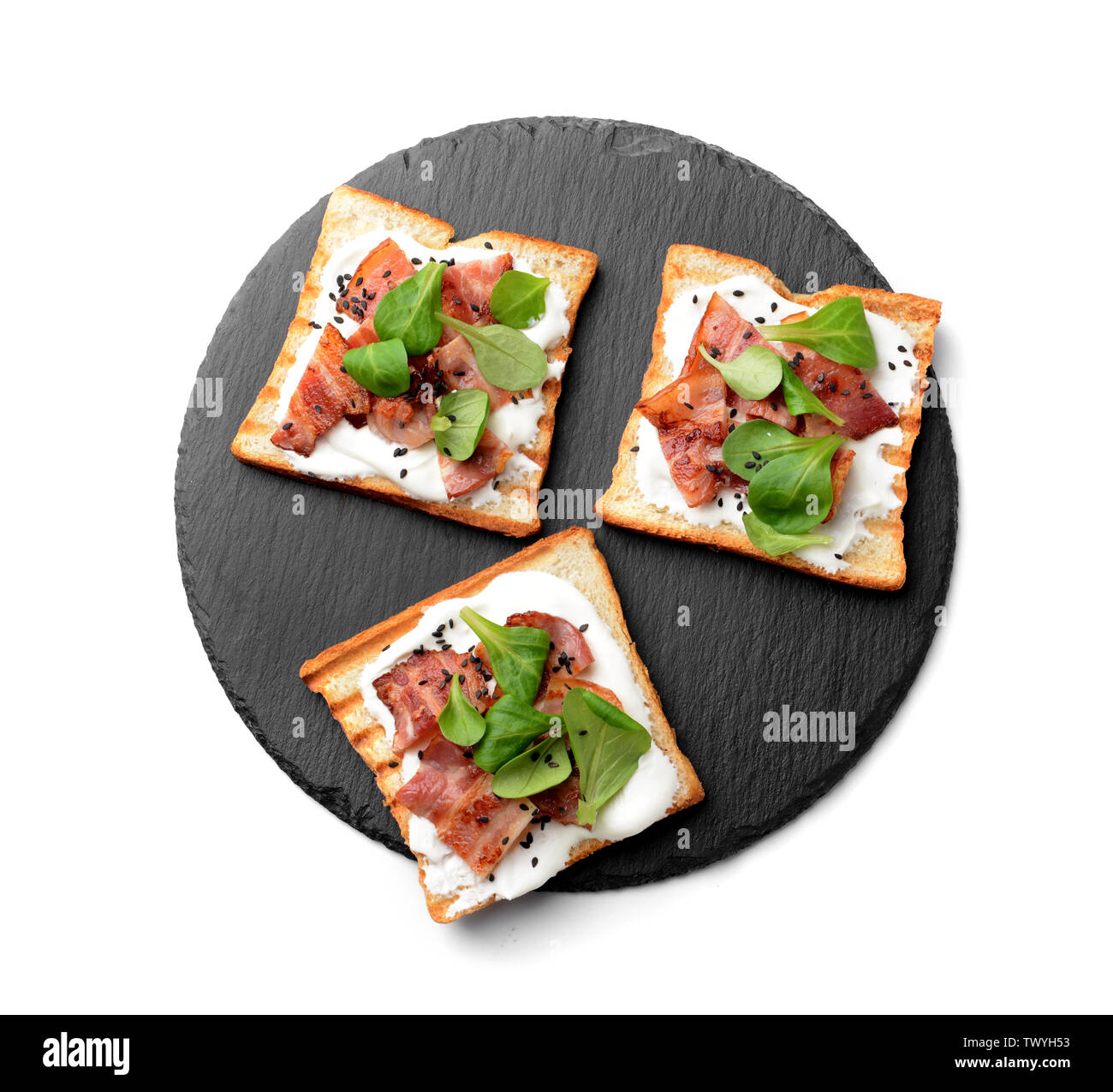 Slate plate with tasty toasts on white background Stock Photo - Alamy