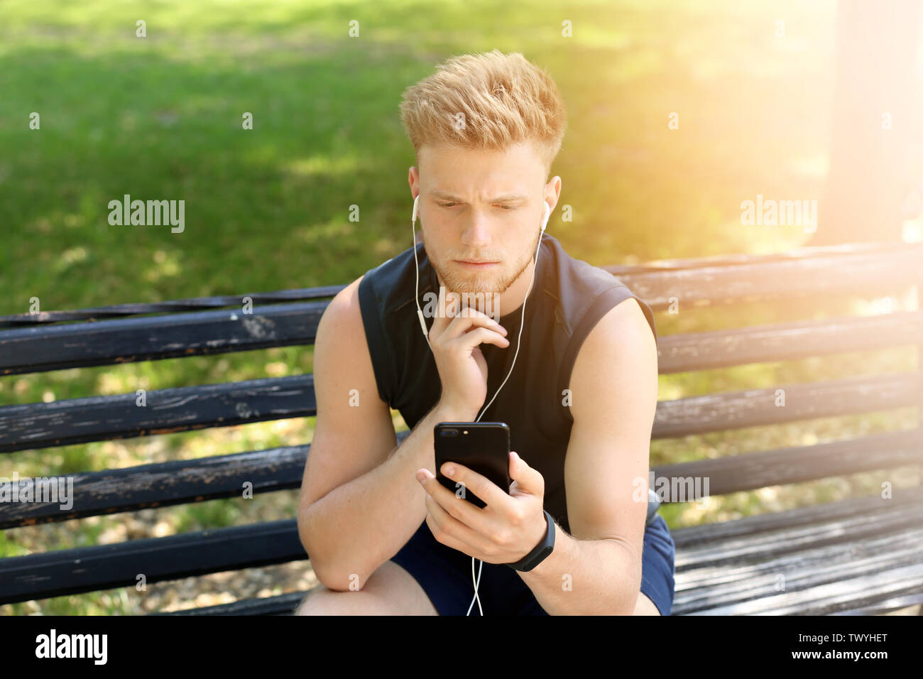 Sporty young man checking his pulse outdoors Stock Photo - Alamy