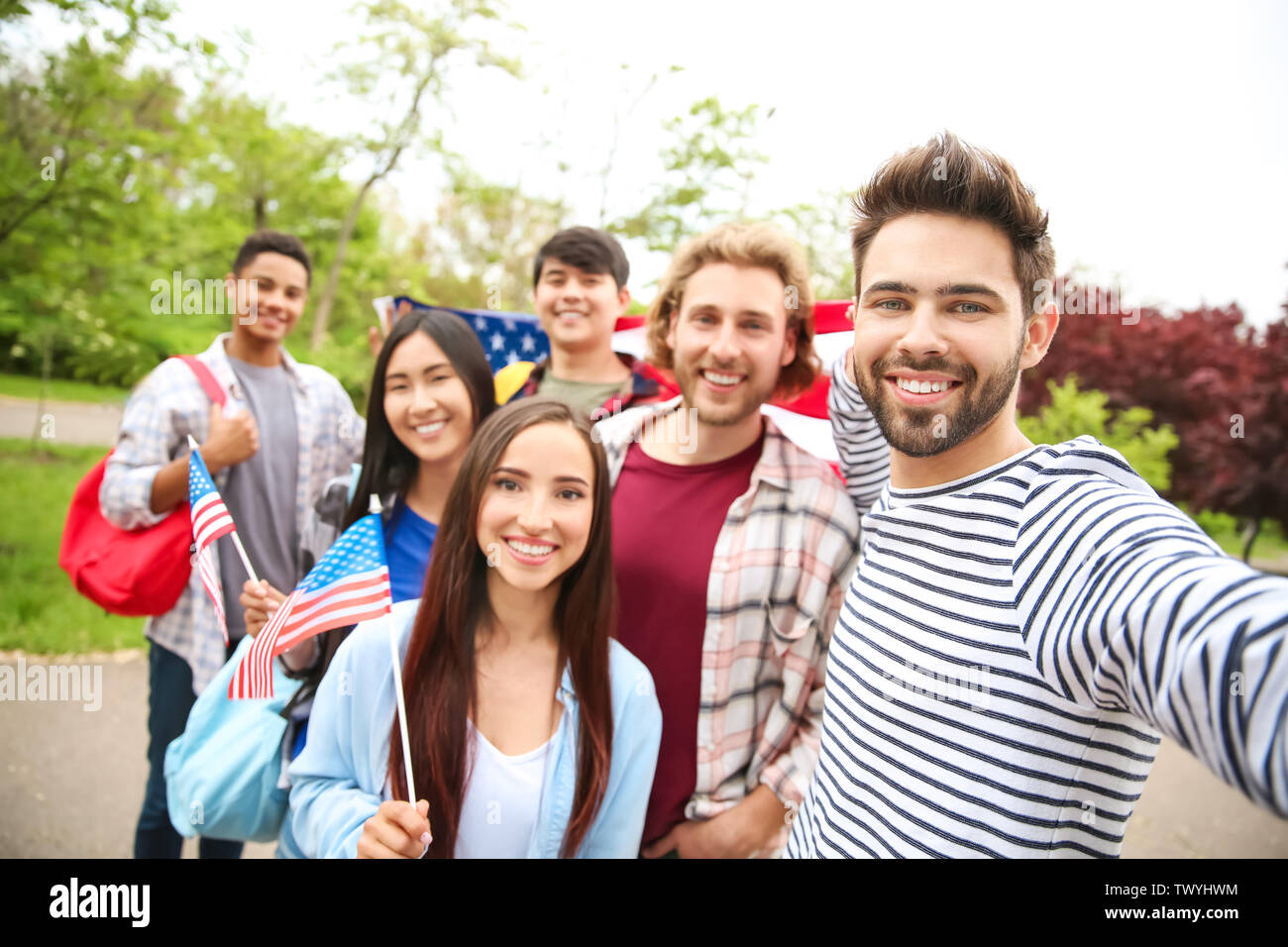 Group of students with USA flag taking selfie outdoors Stock Photo - Alamy