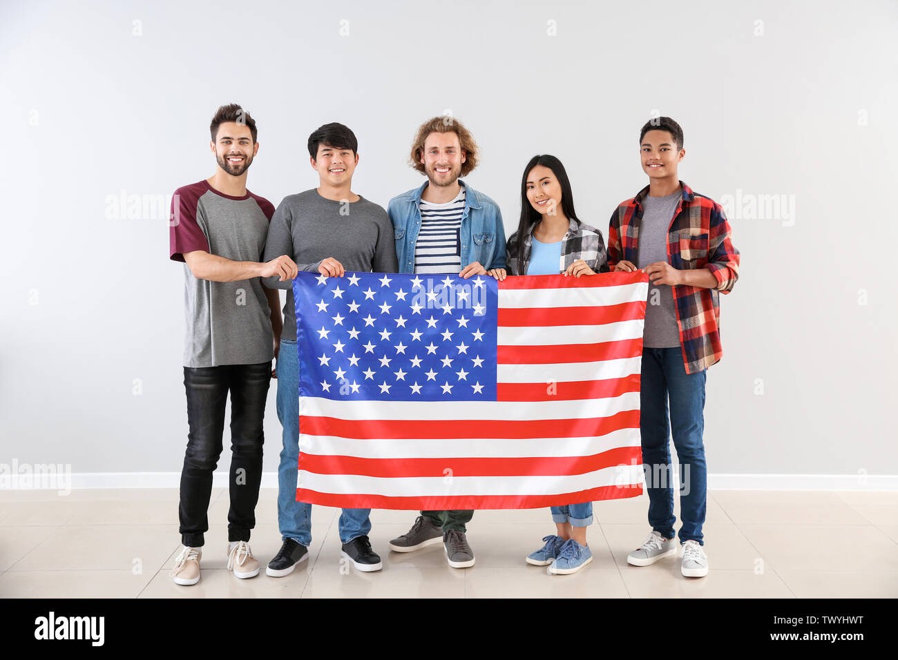 Group of students with USA flag near light wall Stock Photo - Alamy