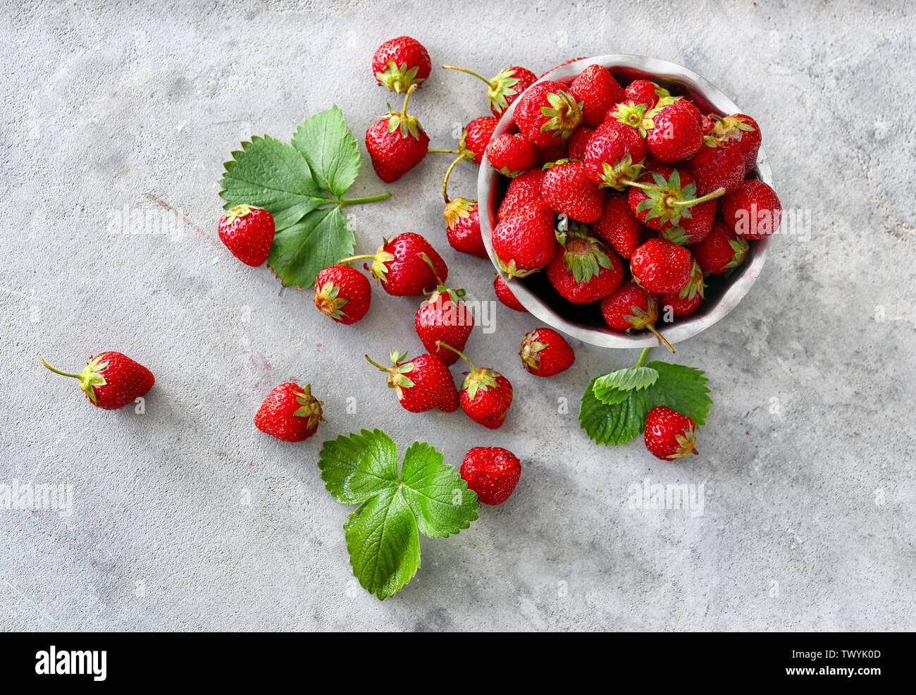 Colander with ripe red strawberry on table Stock Photo - Alamy