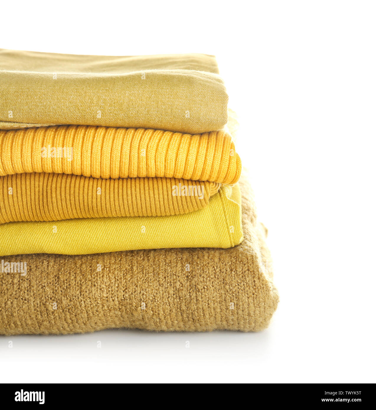 Stack of modern clothes on white background Stock Photo - Alamy