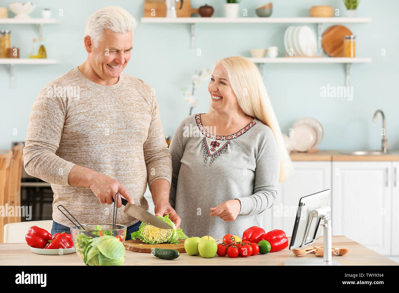Caucasian elderly couple cooking romantic hi-res stock photography and ...