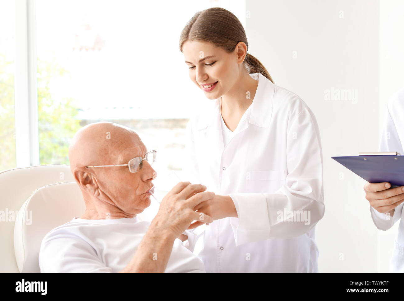 Doctor drinking water in clinic hi-res stock photography and images - Alamy