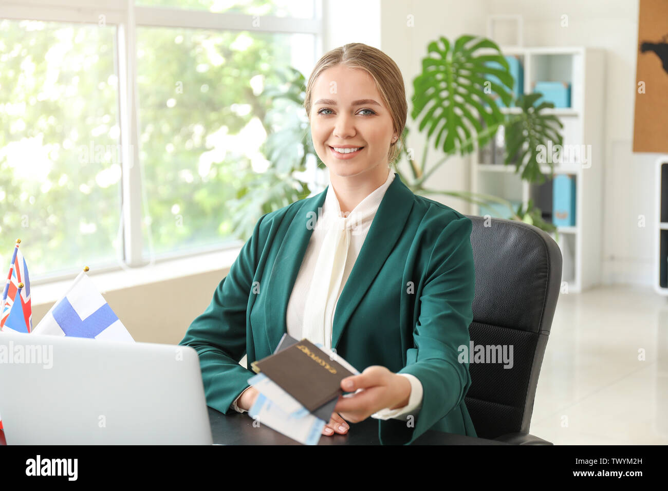 Female travel agent with passports and tickets in office Stock Photo ...
