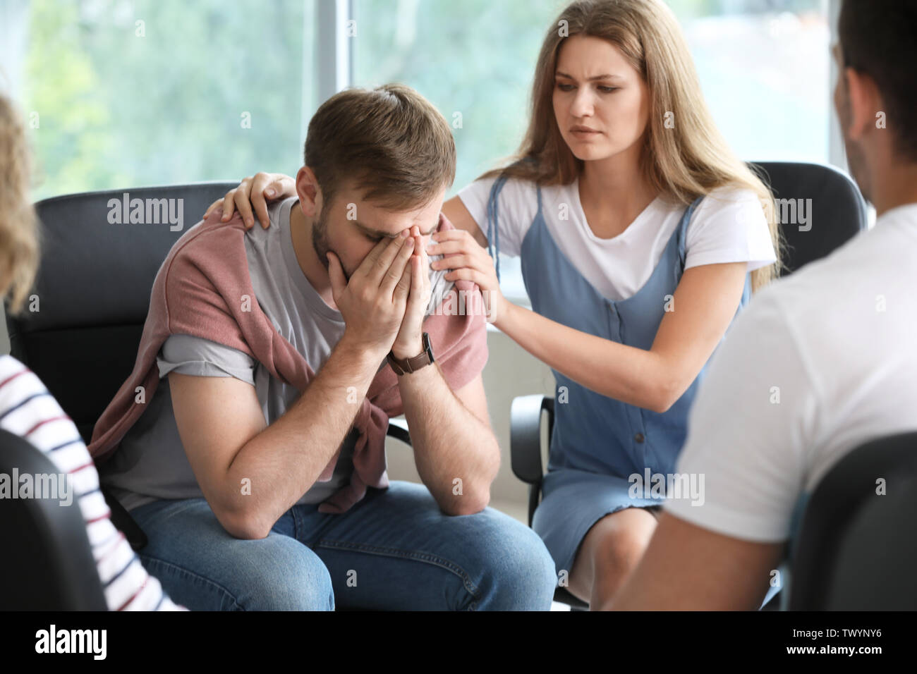 Sad young man at group therapy session Stock Photo - Alamy