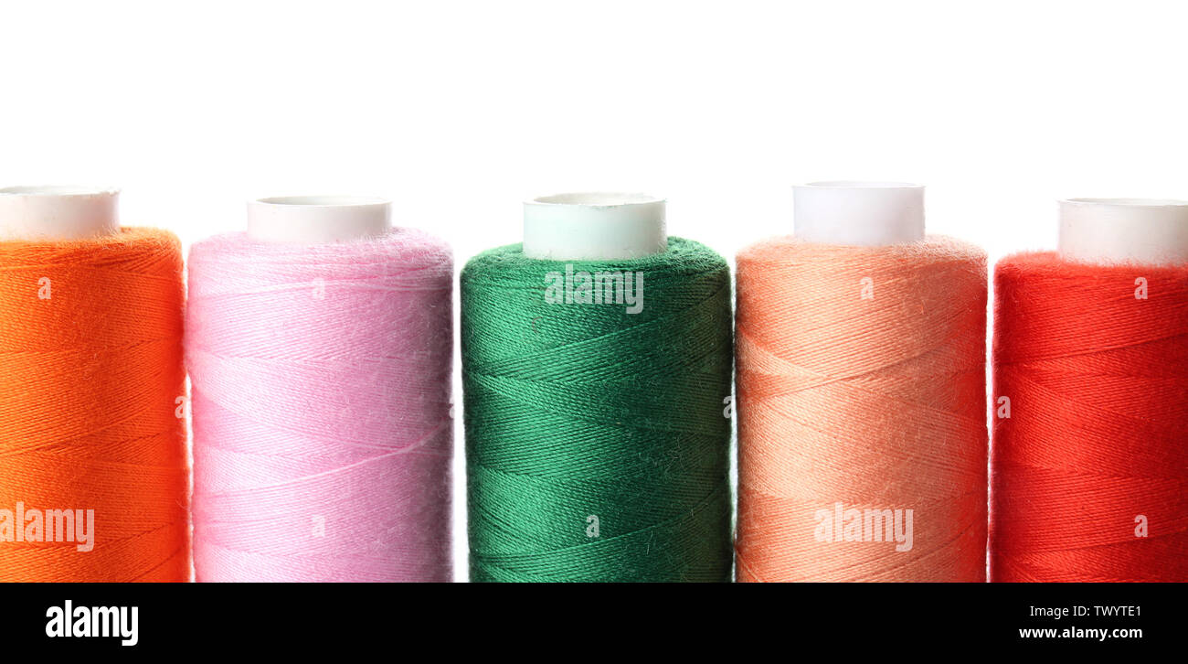 Colorful sewing threads on white background Stock Photo - Alamy