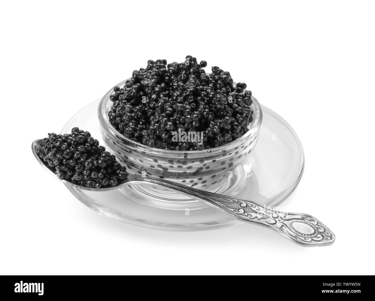 Bowl and spoon with delicious black caviar on white background Stock ...