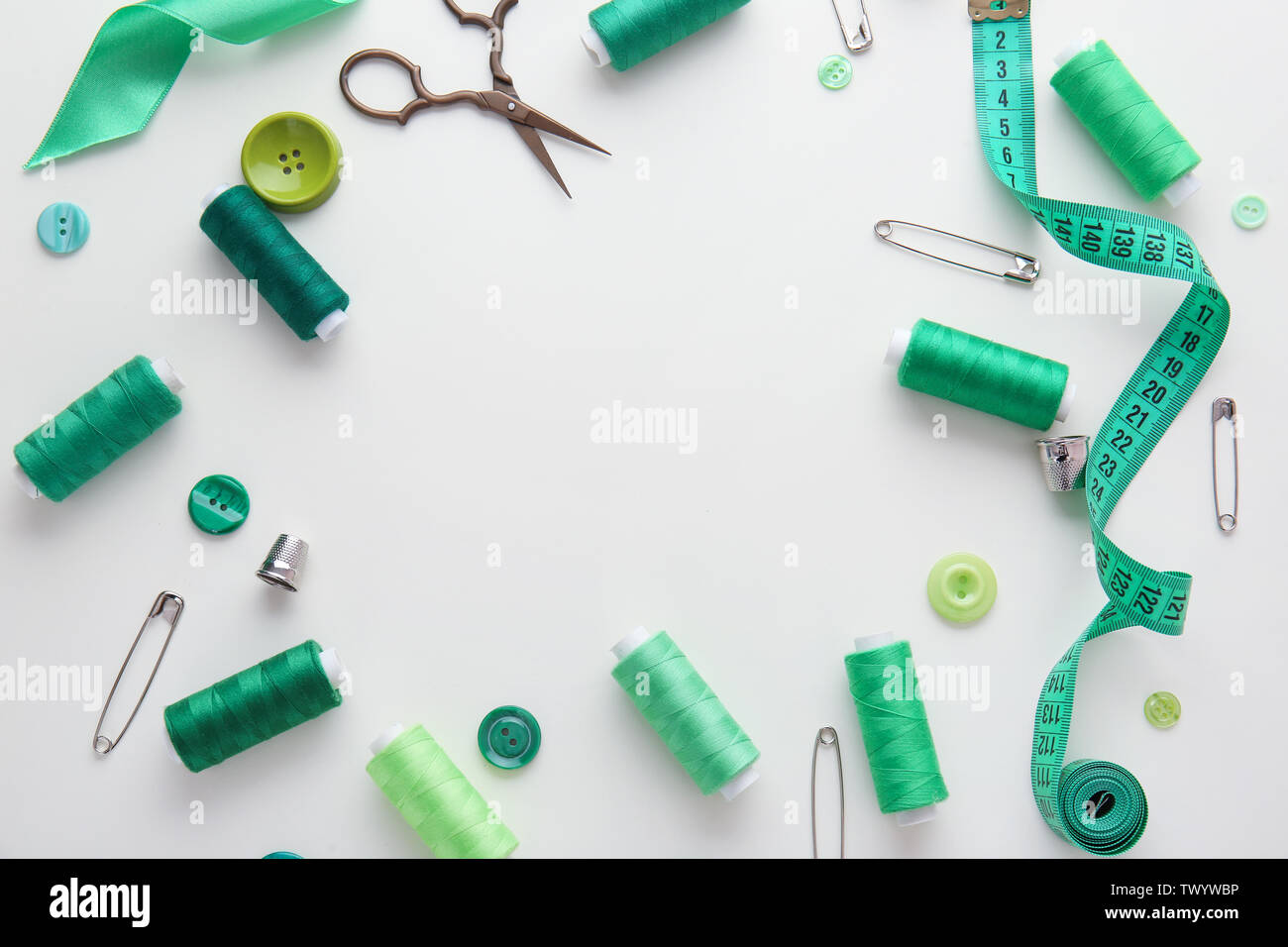 Frame made of sewing threads and accessories on white background Stock ...