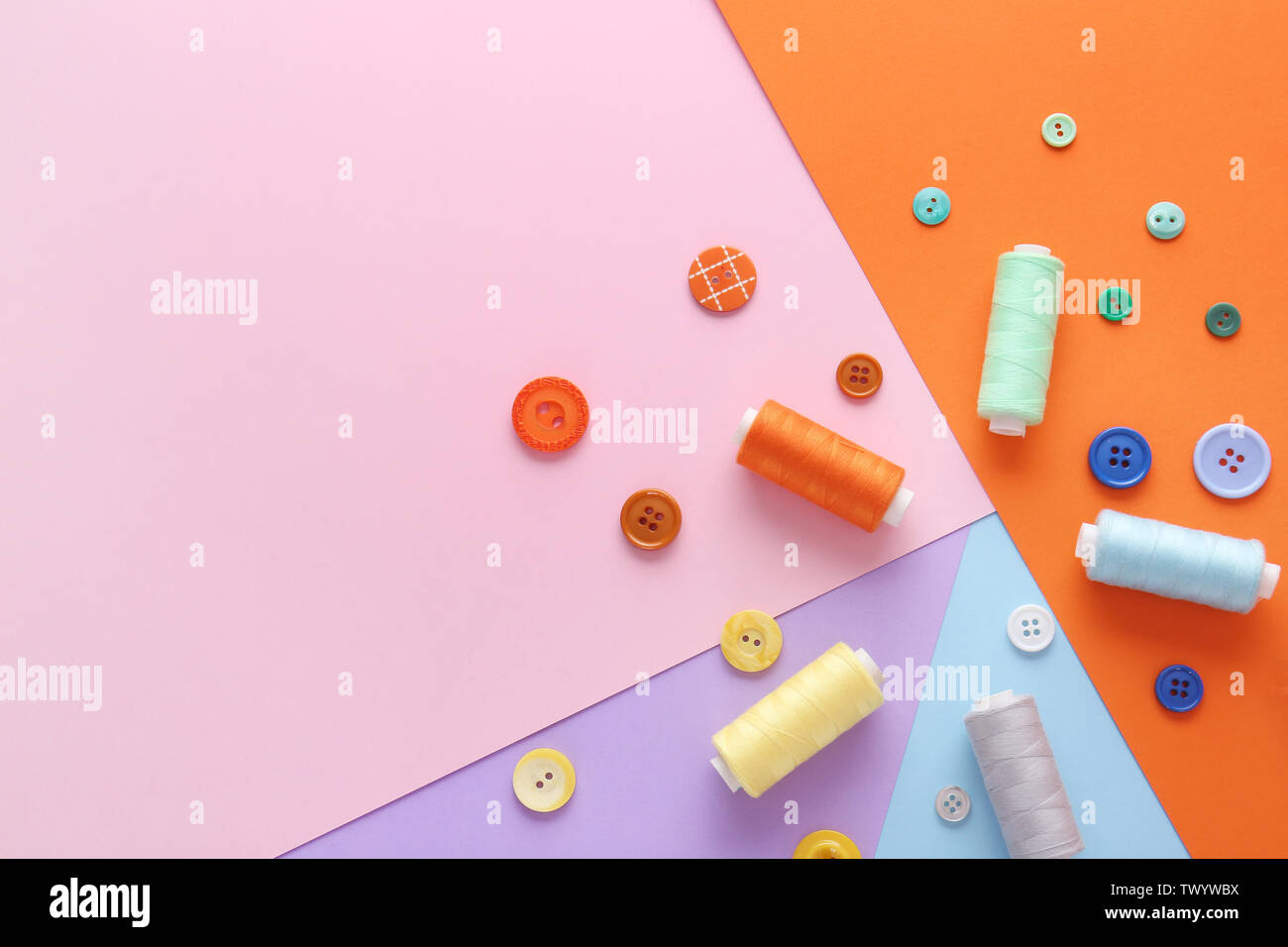 Set of sewing threads and buttons on color background Stock Photo - Alamy
