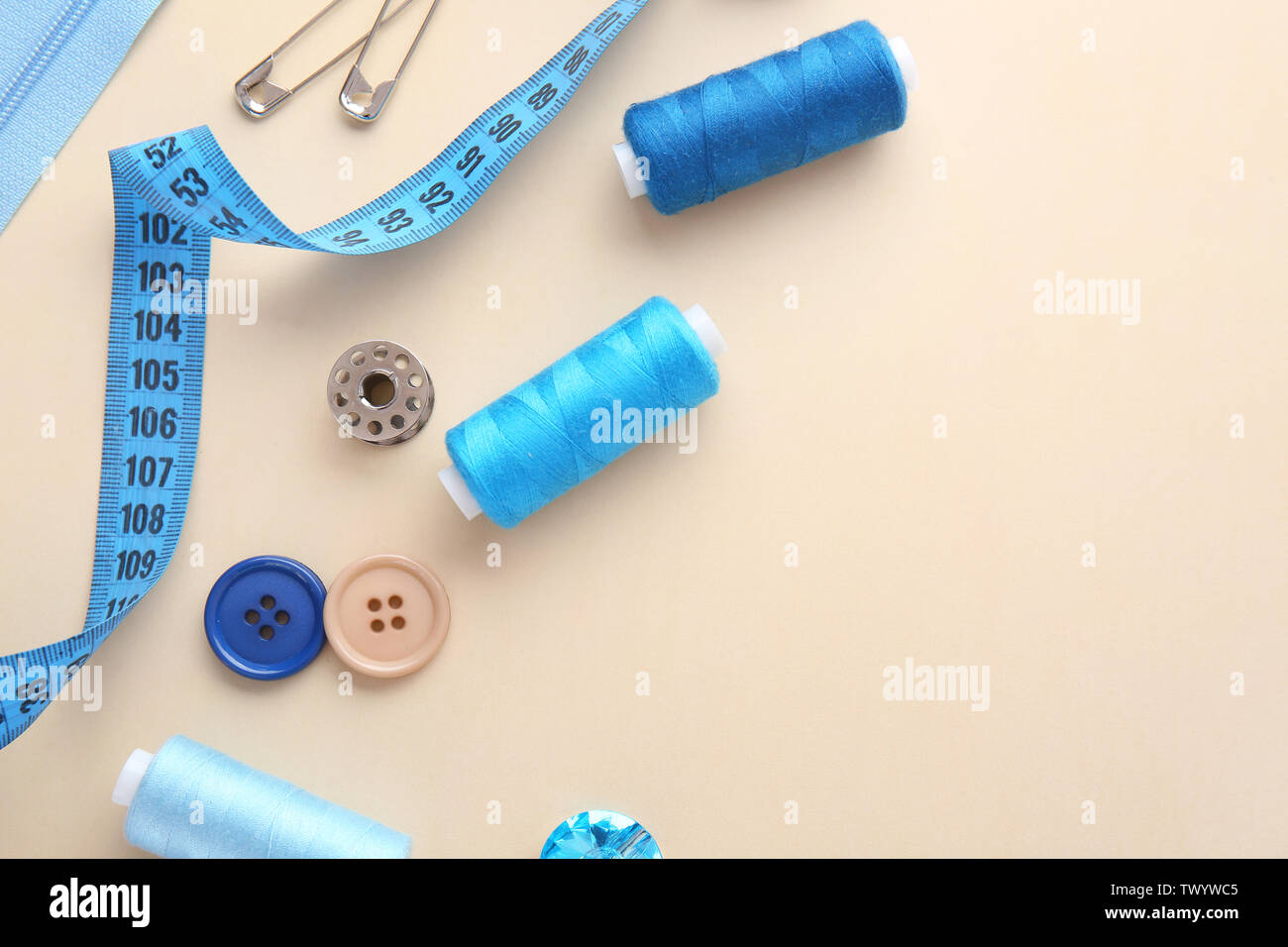 Set of sewing threads and accessories on color background Stock Photo ...