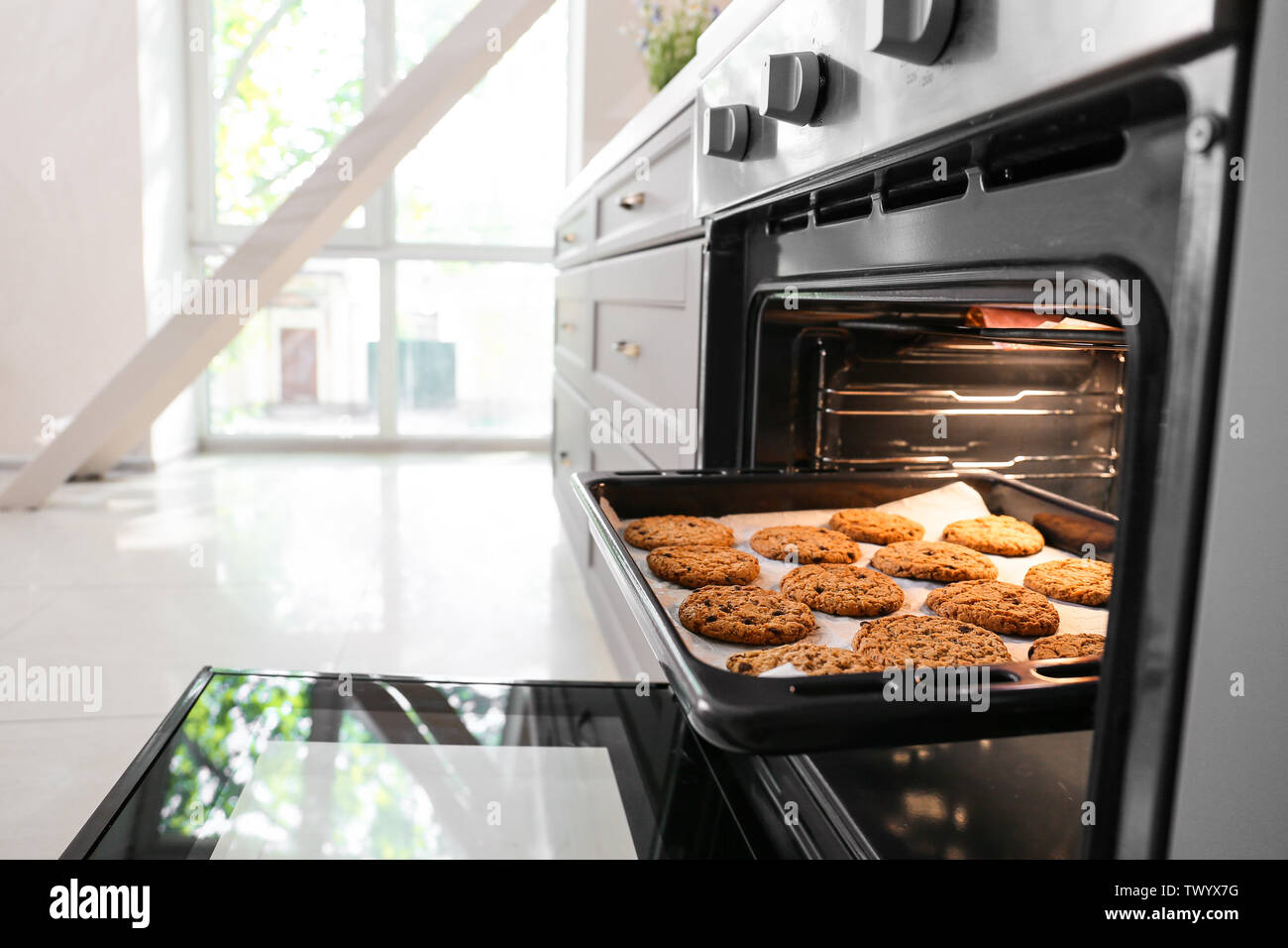 Open oven with tasty homemade cookies in kitchen Stock Photo - Alamy